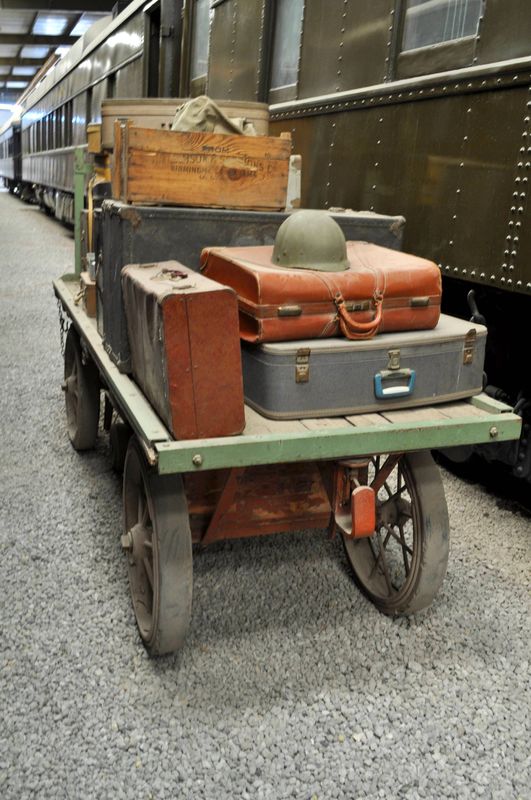 Cases on platform: A selection of cases and historic trolley on a local ...