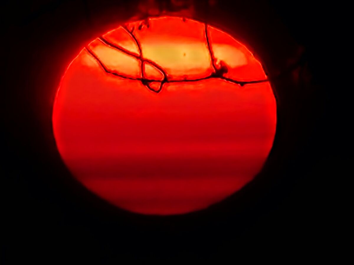Rising Setting: . This red sun is simultaneously rising over Cape Cod ...